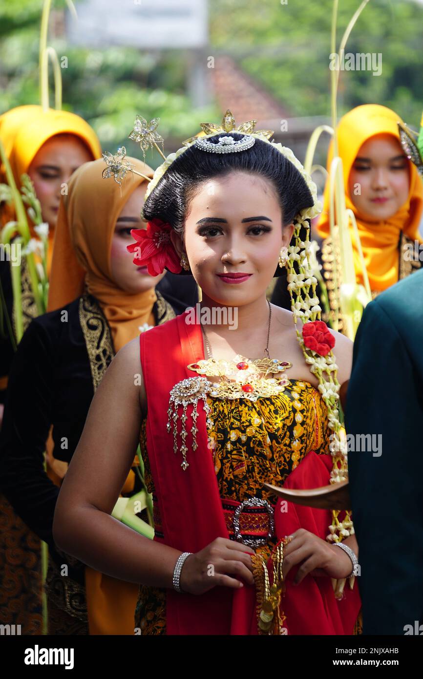 Indonesian with a traditional javanese cloth on 1800 chocolate ketupat ...