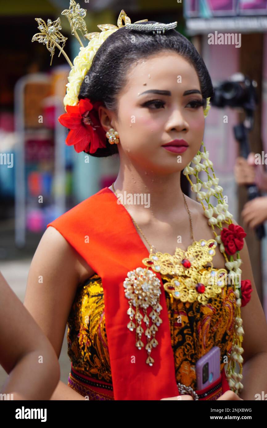 Indonesian with a traditional javanese cloth on 1800 chocolate ketupat ...