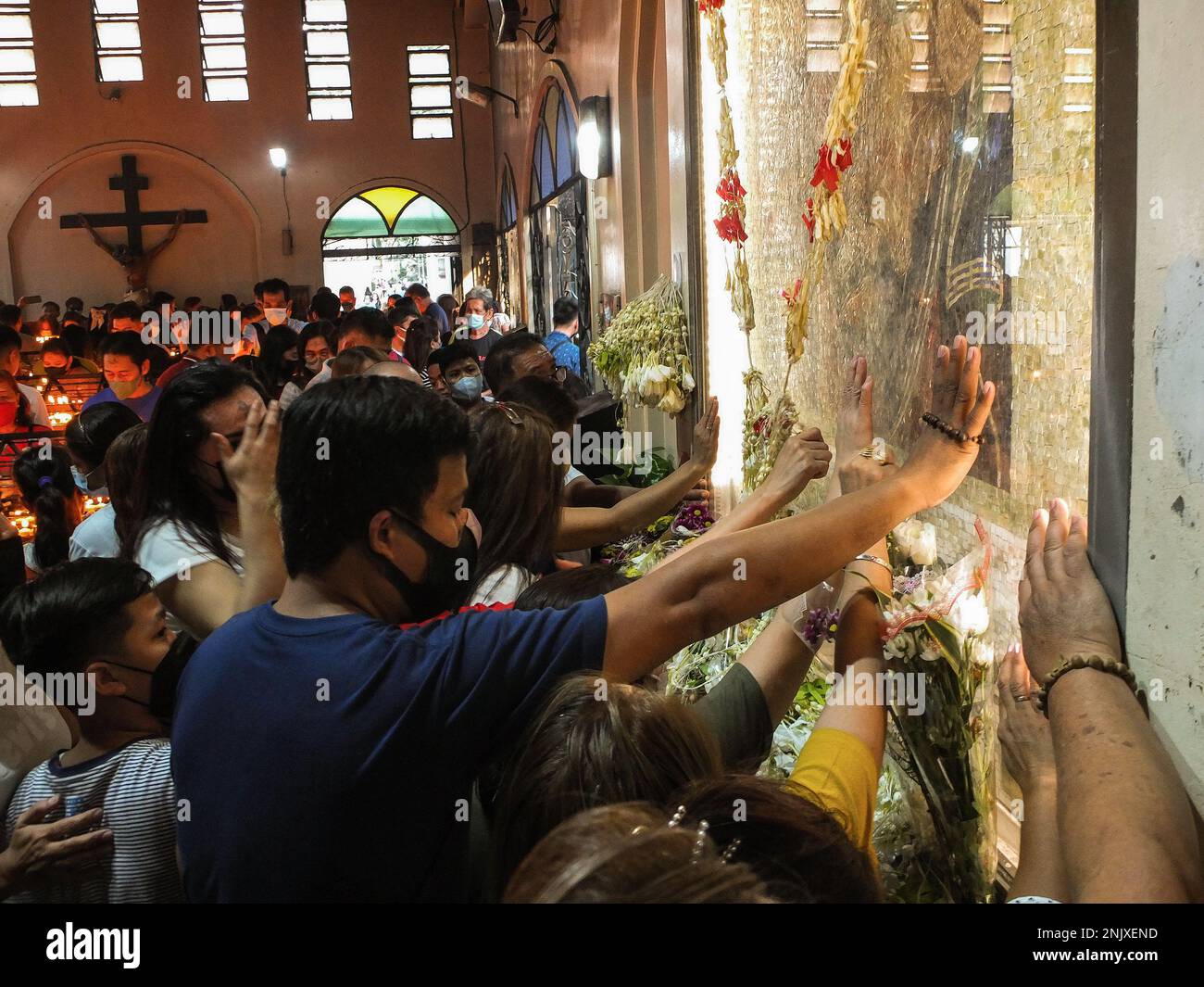Devotees touch image of the Mother of Perpetual Help after lighting ...