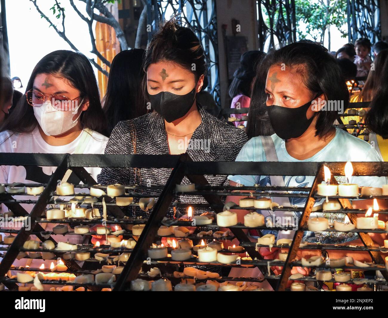 Catholic devotees seen praying at the candle chapel of the Baclaran ...