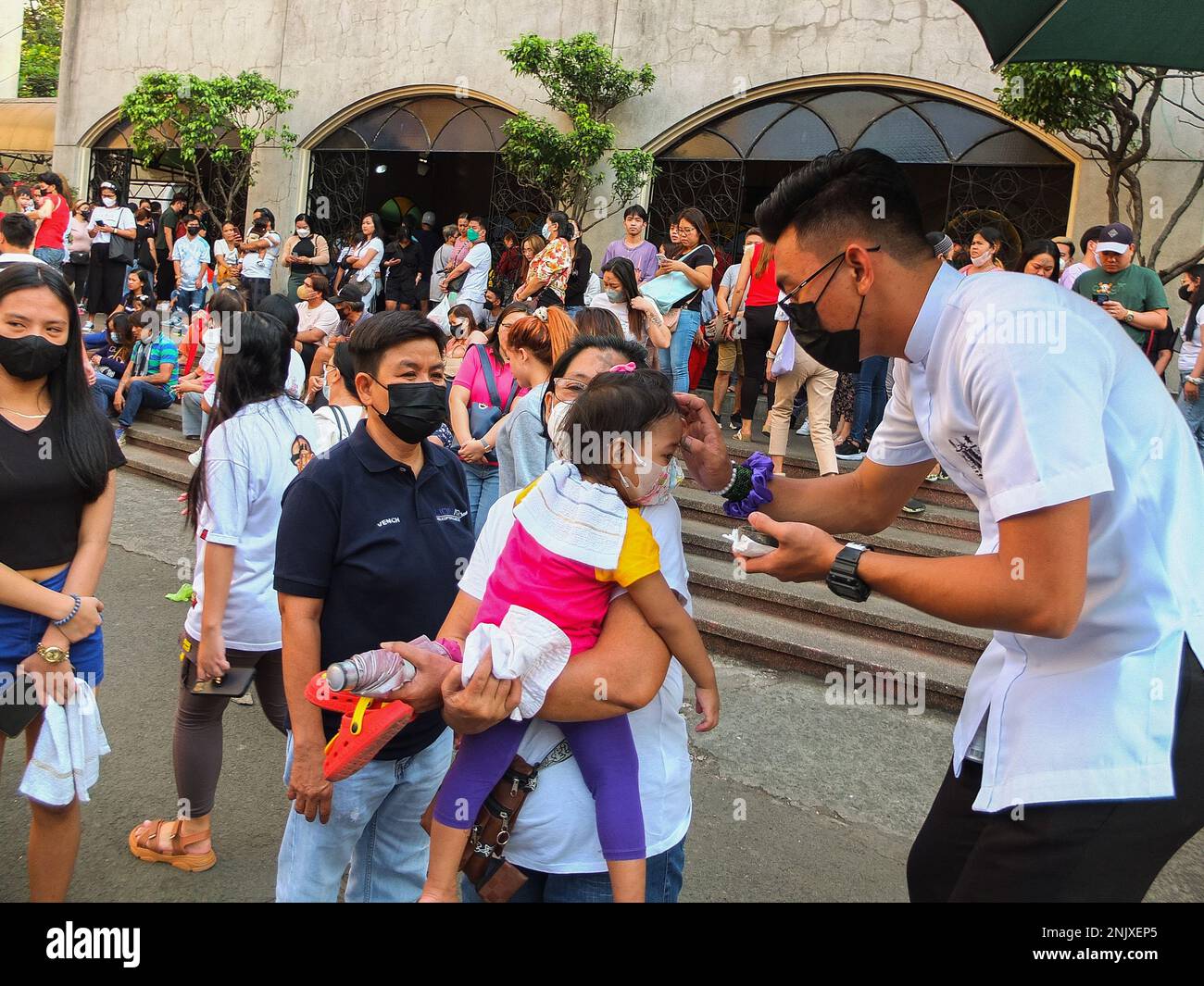 A kid receives ash marking on her forehead. Catholic faithful receive ...