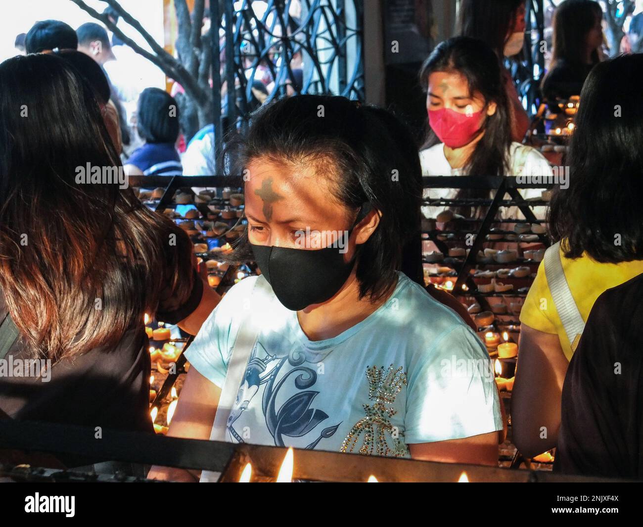 Catholic devotees seen praying at the candle chapel of the Baclaran ...