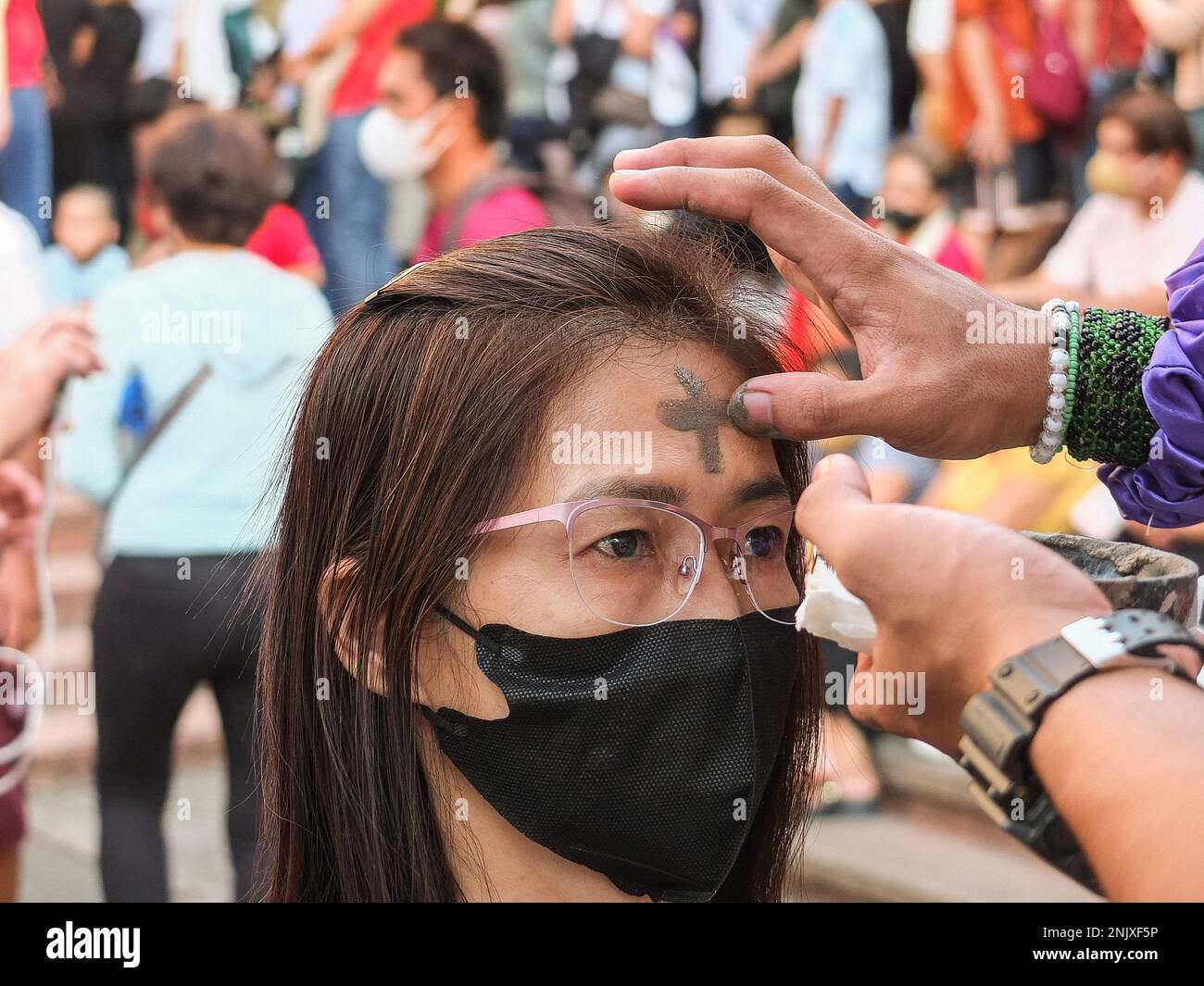 A female devotee receives ash marking on her forehead. Catholic ...