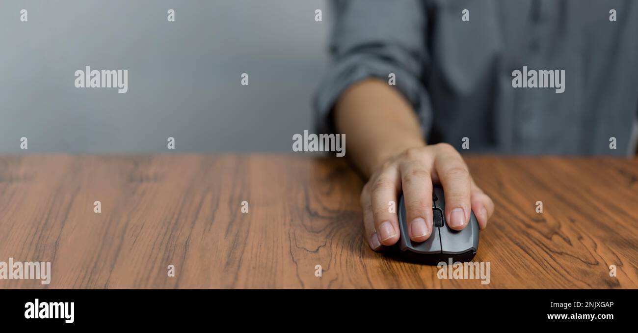Male hand holding computer mouse with copy space Stock Photo - Alamy