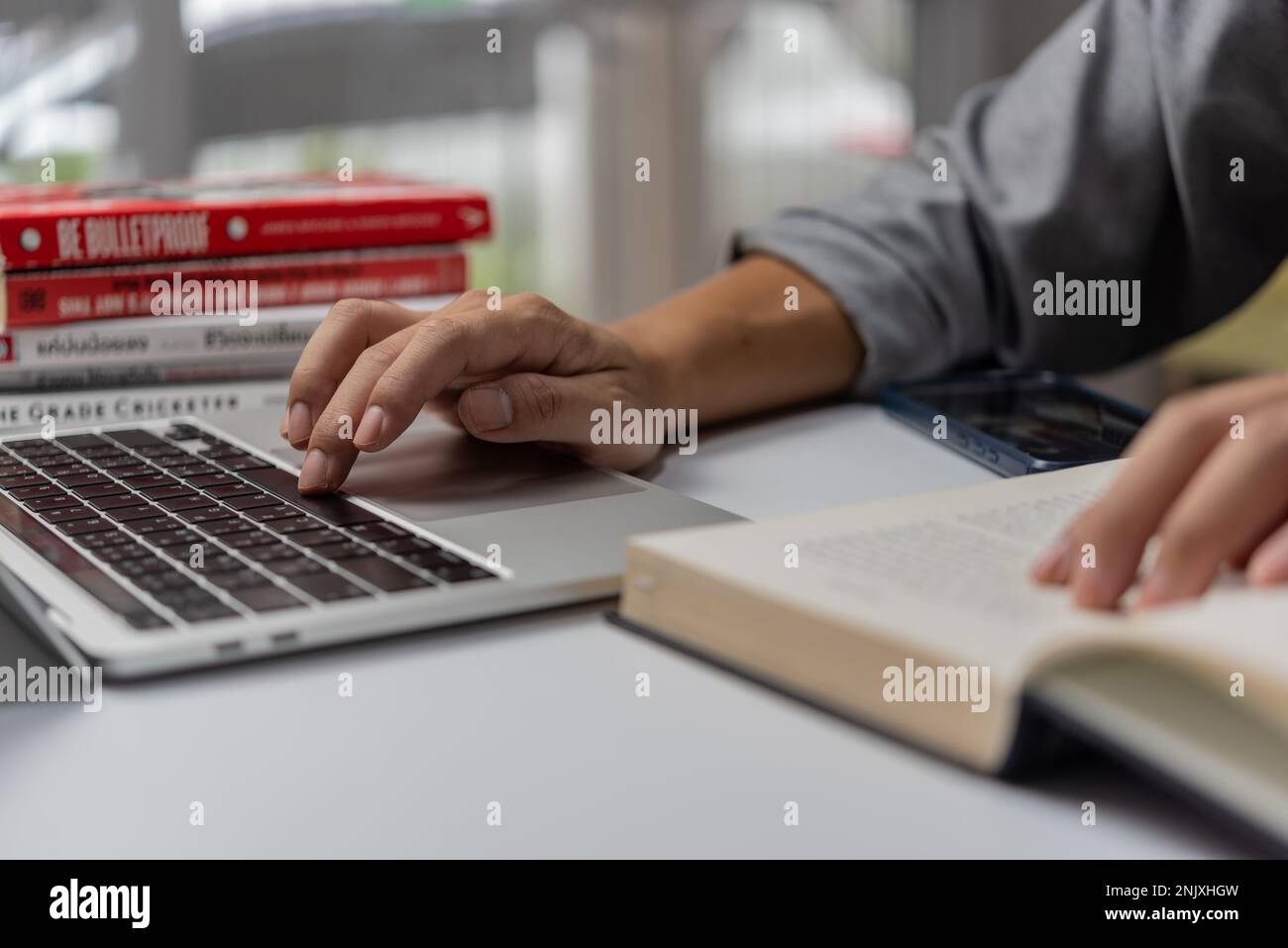 learning online class by using laptop computer and writing notebook at ...