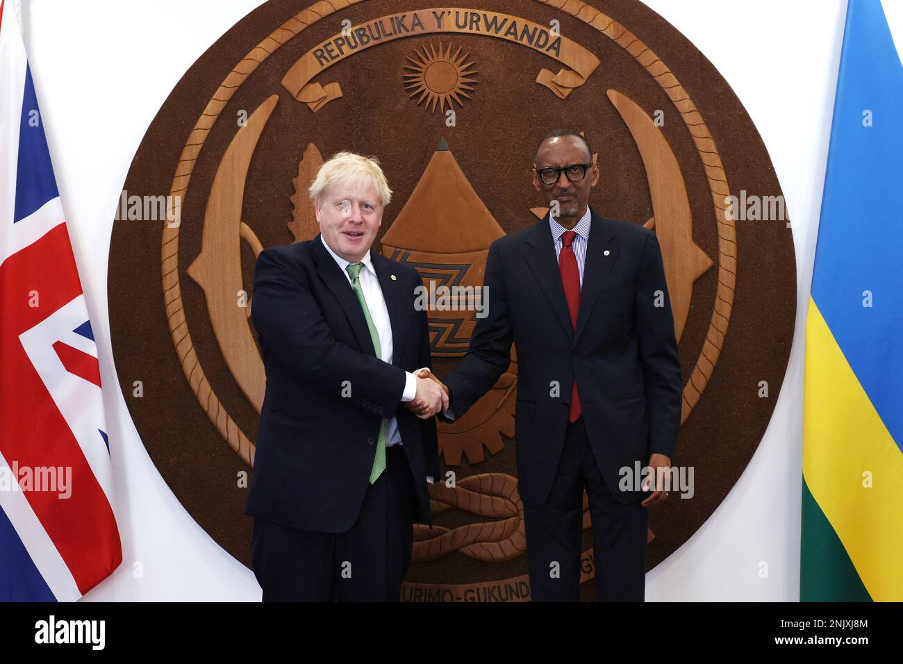 British Prime Minister Boris Johnson, left, shakes hands with Rwandan ...