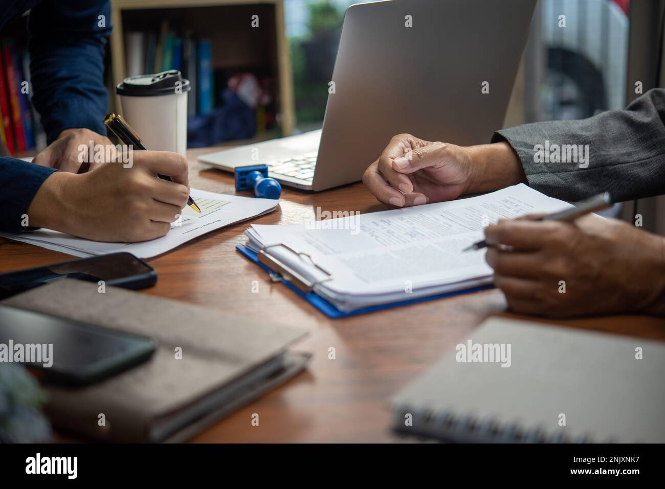 manager or hr reading a resume during a job interview of employees who ...