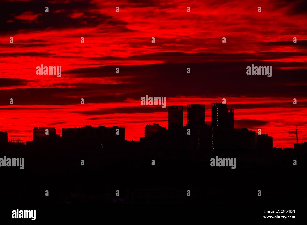 Colorful red sunrise over city and dramatic sky with clouds Stock Photo ...