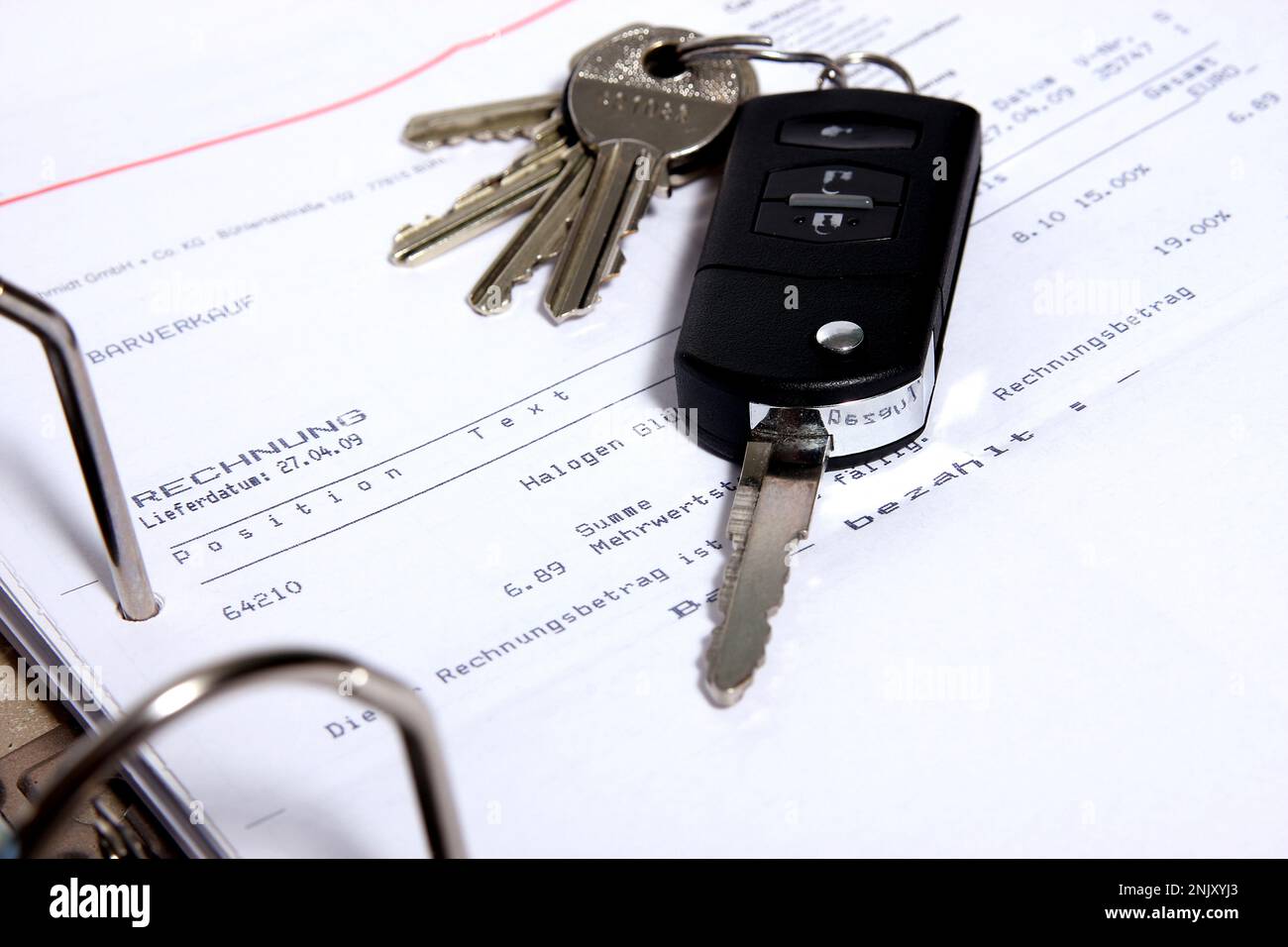 open filing folder with bill and car key Stock Photo - Alamy