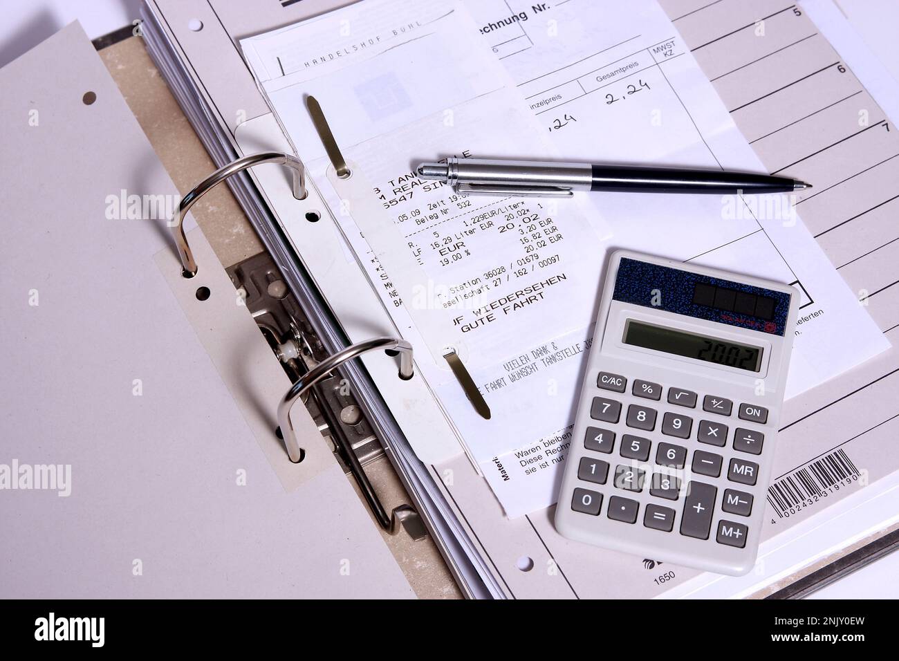 open filing folder with ballpen and calculator Stock Photo - Alamy