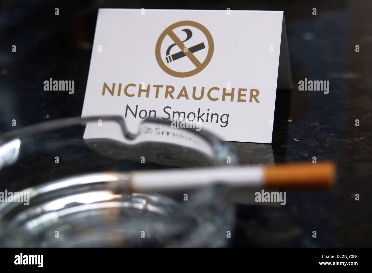 cigarette in ashtray and non-smoking sign Stock Photo - Alamy
