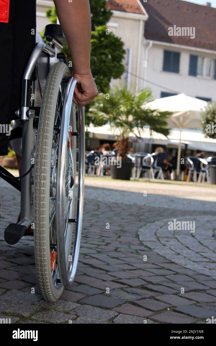 woman in a wheelchair on a pavement, detail Stock Photo - Alamy