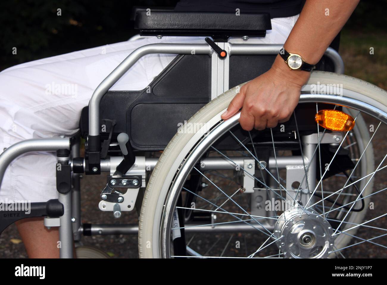 woman in a wheelchair on a path, detail Stock Photo - Alamy