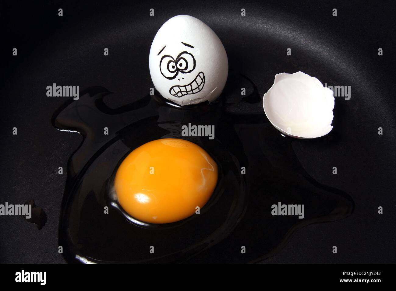 egg in the pan, painted with a bad-tempered face Stock Photo - Alamy