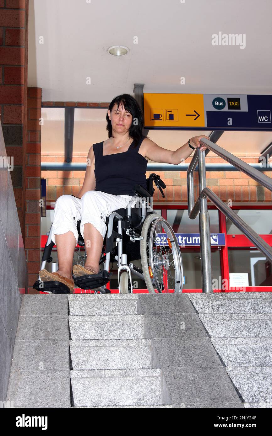 woman in a wheelchair at the with pram ramp at the train station, not ...