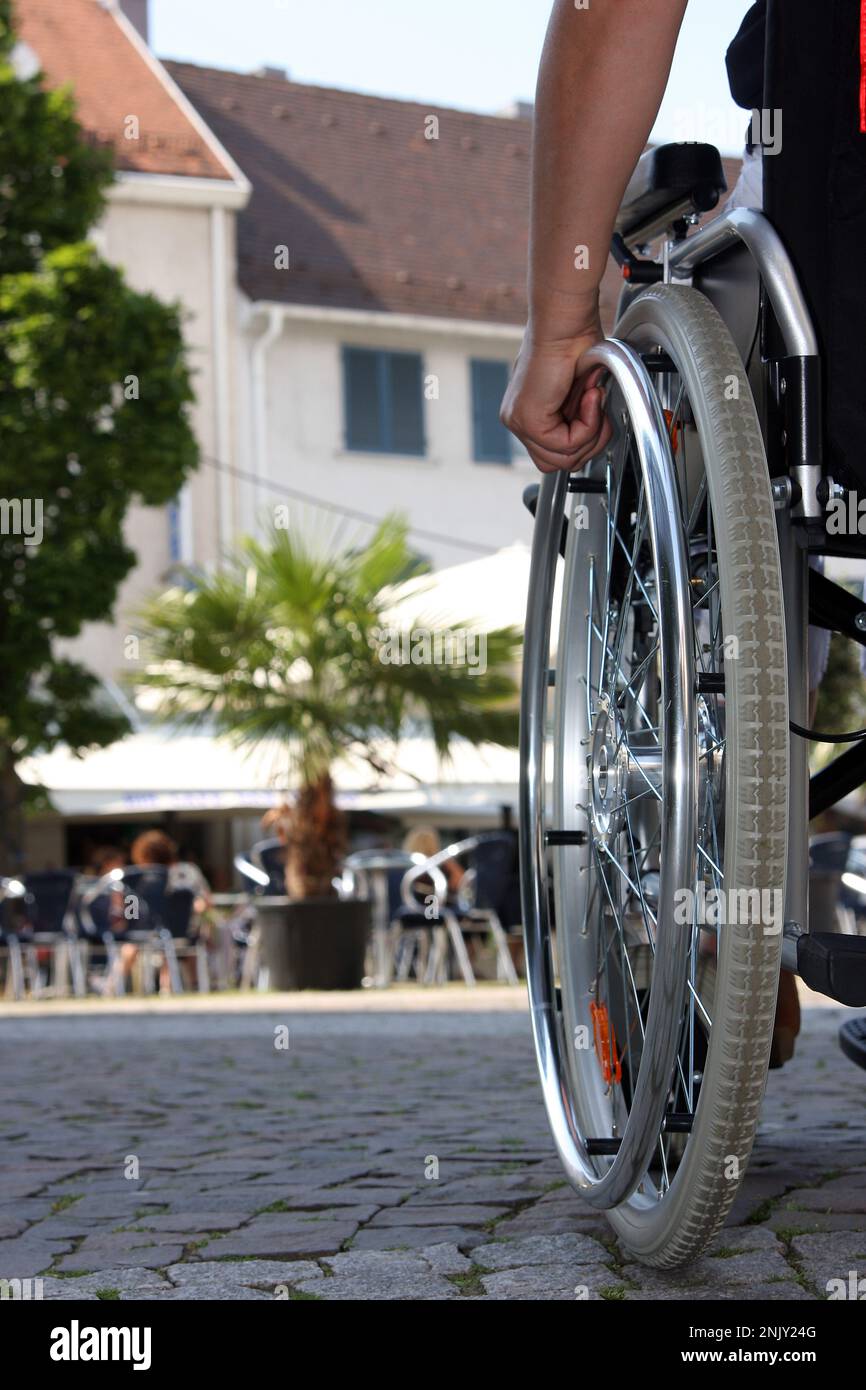woman in a wheelchair on a pavement, detail Stock Photo - Alamy