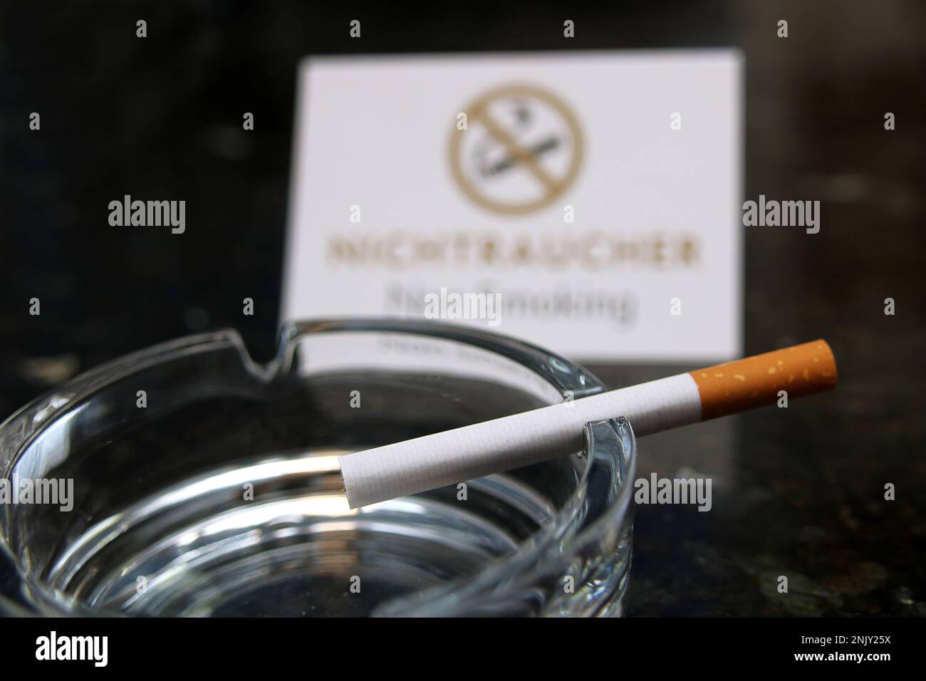 cigarette in ashtray and non-smoking sign Stock Photo - Alamy