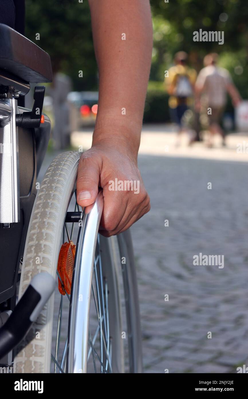 woman in a wheelchair on a pavement, detail Stock Photo - Alamy
