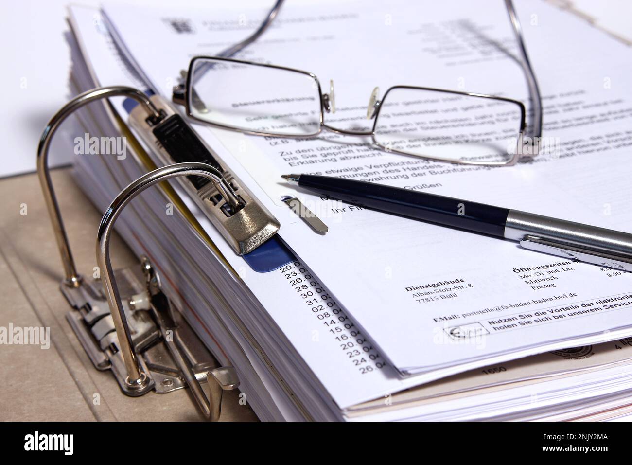 open filing folder with ballpen and spectacles Stock Photo - Alamy