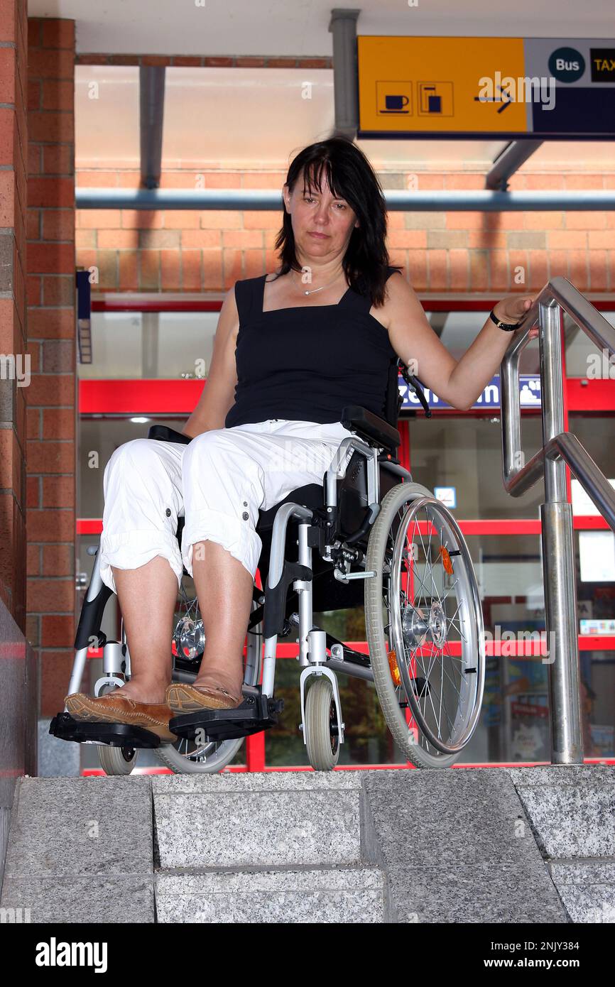 woman in a wheelchair at the with pram ramp at the train station, not ...