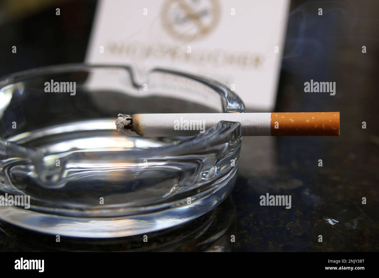 cigarette in ashtray and non-smoking sign Stock Photo - Alamy