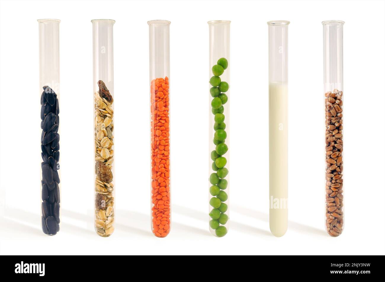 Food-cereals, legumes and milk in a test tubes on a white background ...