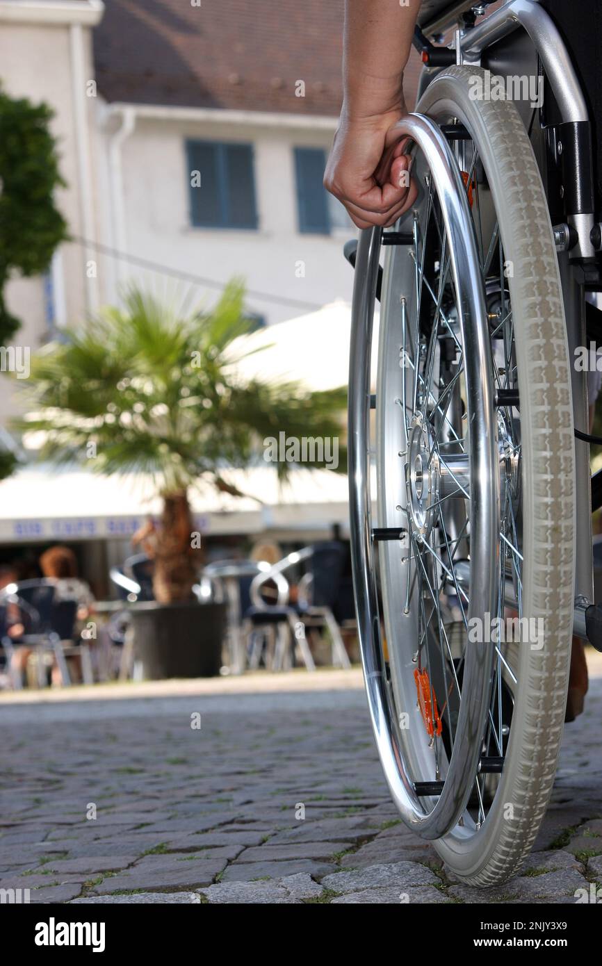 woman in a wheelchair on a pavement, detail Stock Photo - Alamy