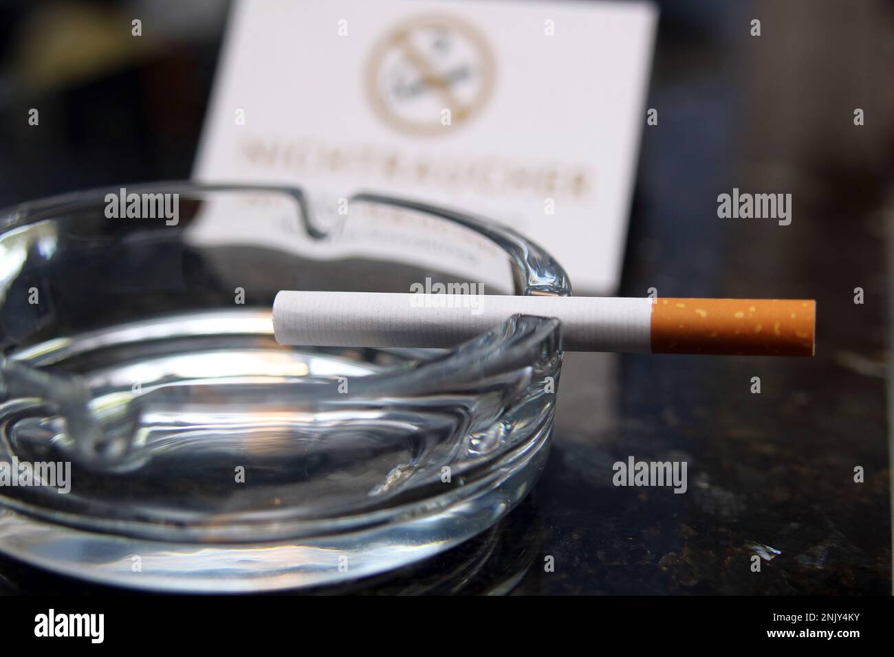 cigarette in ashtray and non-smoking sign Stock Photo - Alamy