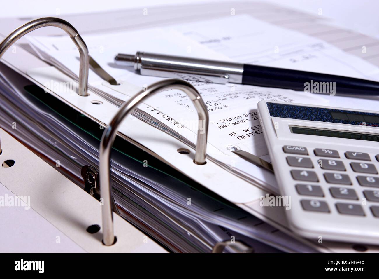open filing folder with ballpen and calculator Stock Photo - Alamy