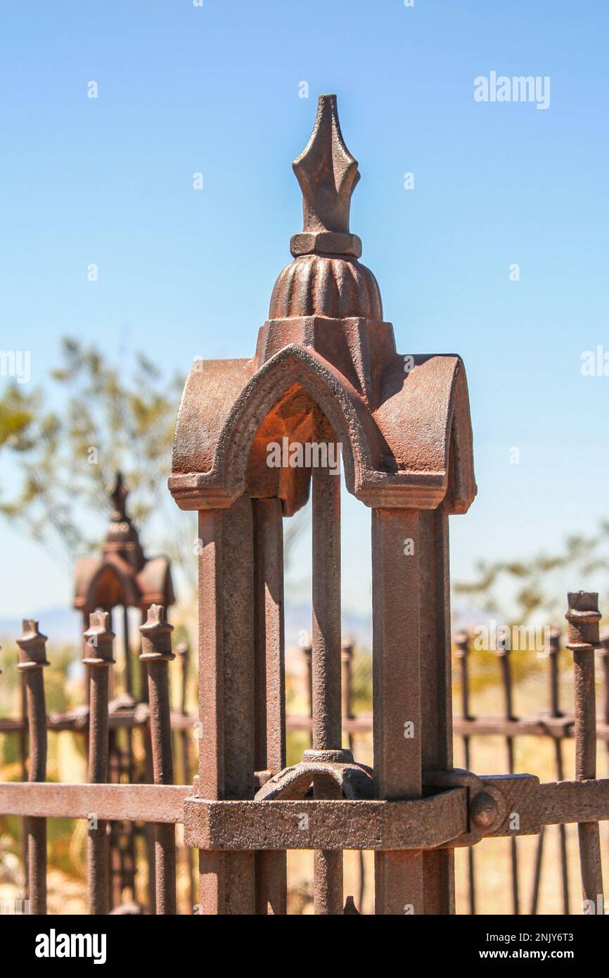 An aged metal gate with a corroded fence post in the cemetery Stock ...