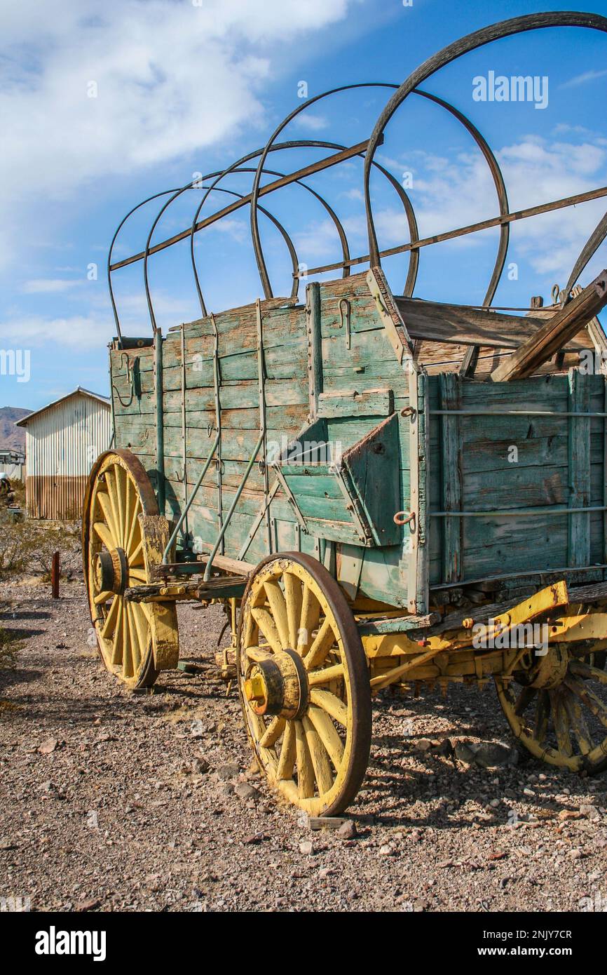 A vintage-style green wagon nestled in the countryside Stock Photo - Alamy