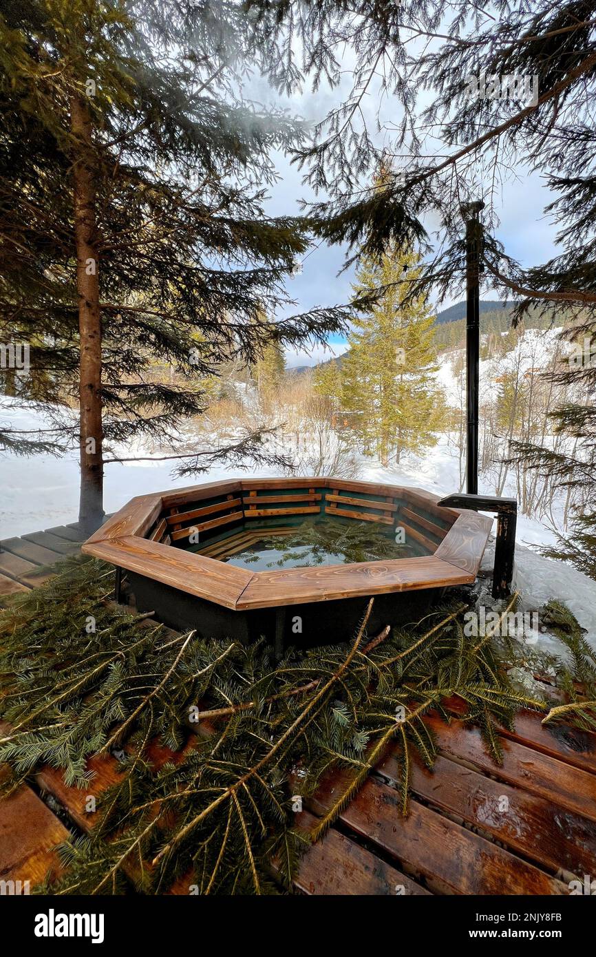outdoor hot wooden tub in high mountains for spa and relaxation between ...
