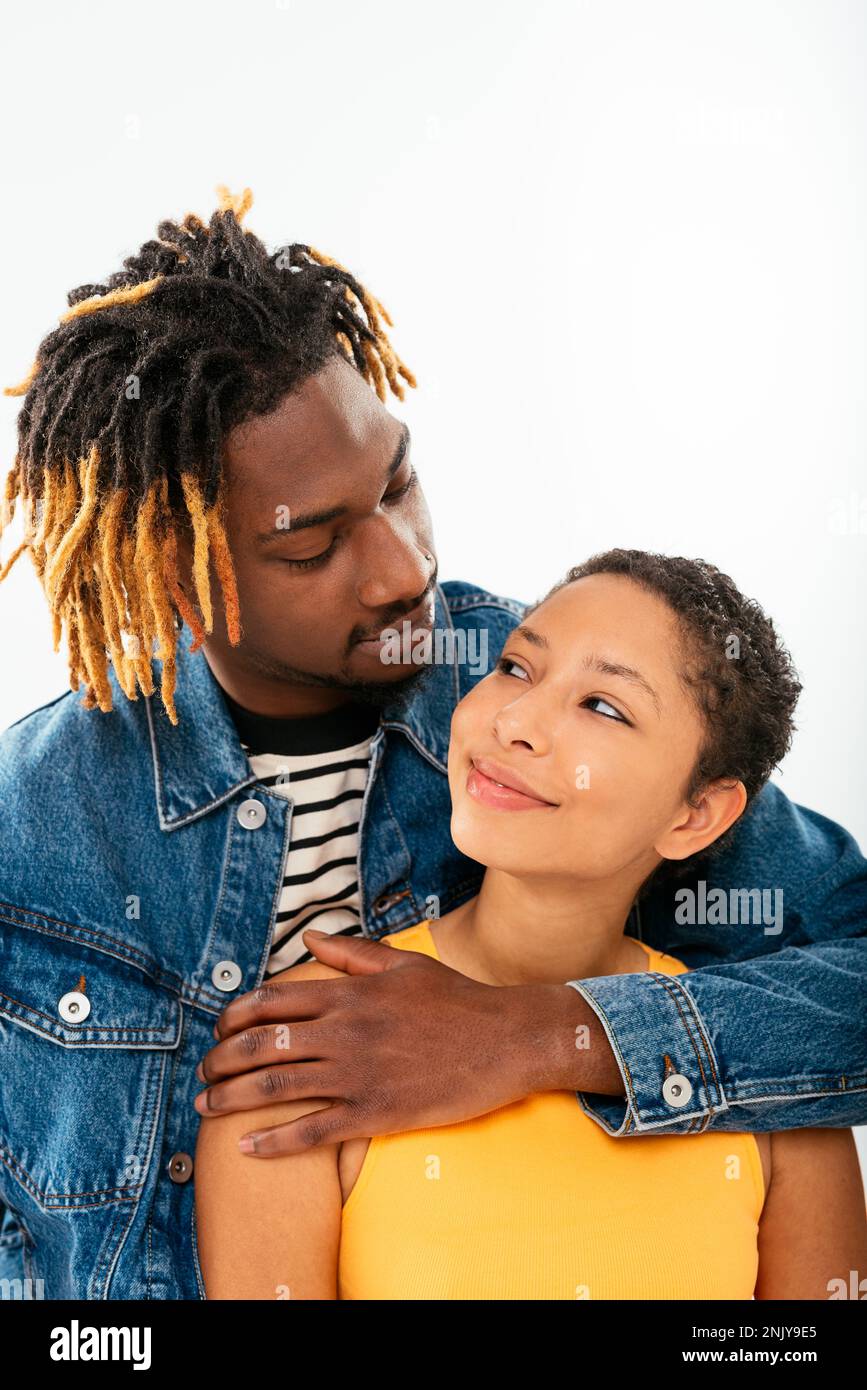 Side view of smiling African American boyfriend with dreadlocks in ...
