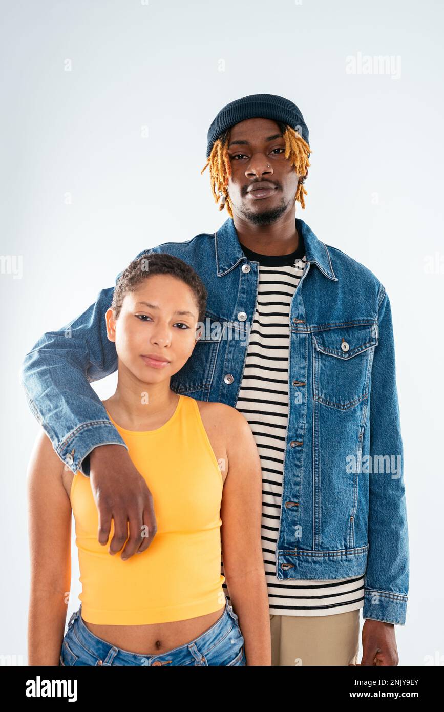 African American boyfriend with dreadlocks in denim jacket hugging ...