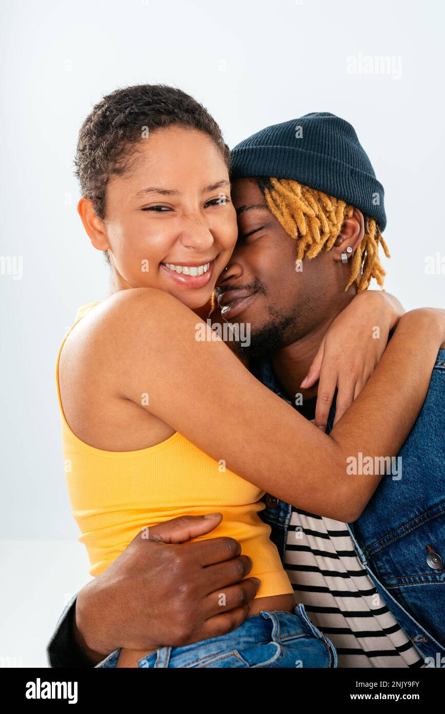 Side view of smiling African American boyfriend with dreadlocks in ...
