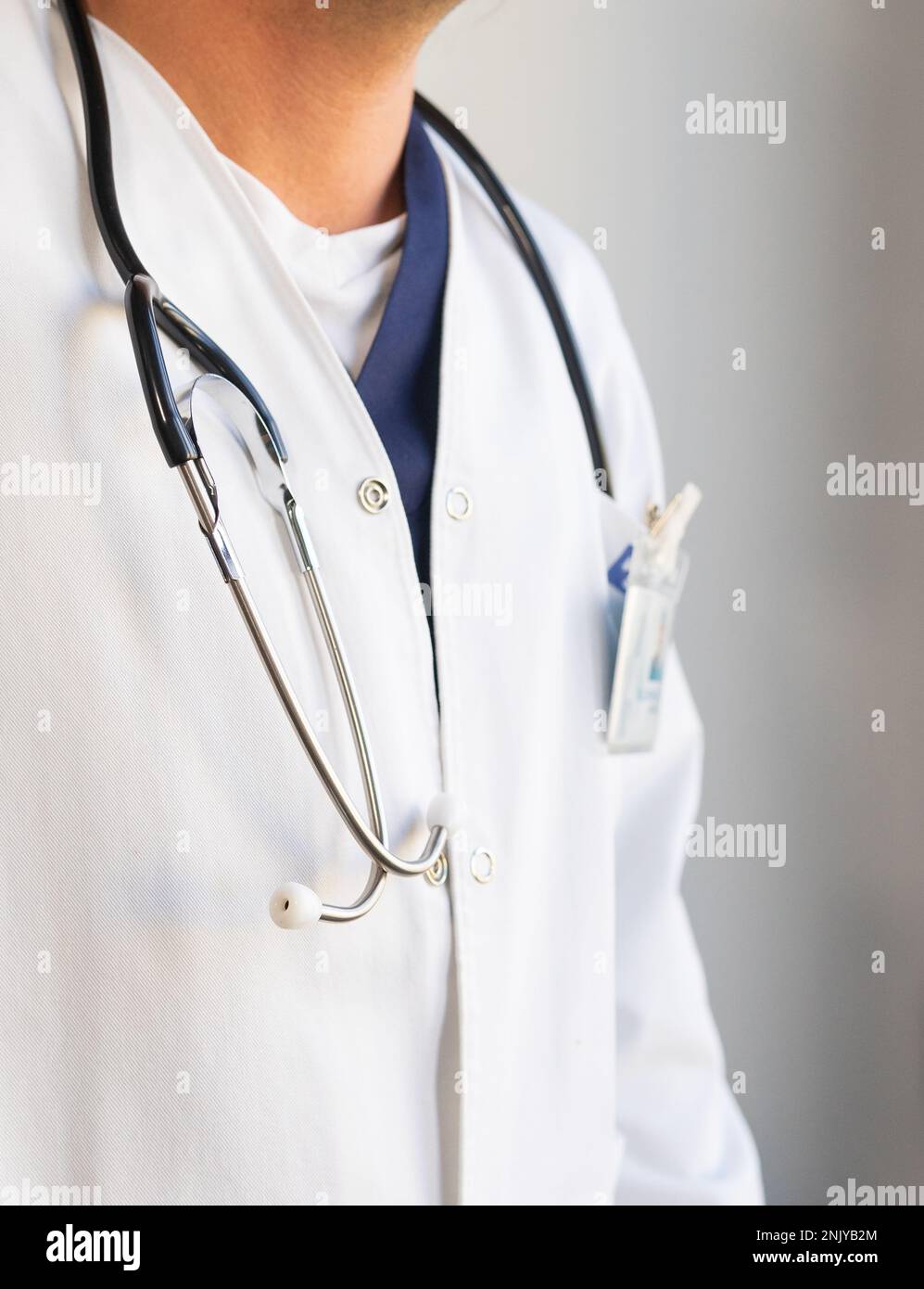 Anonymous male doctor in white uniform with stethoscope on neck ...