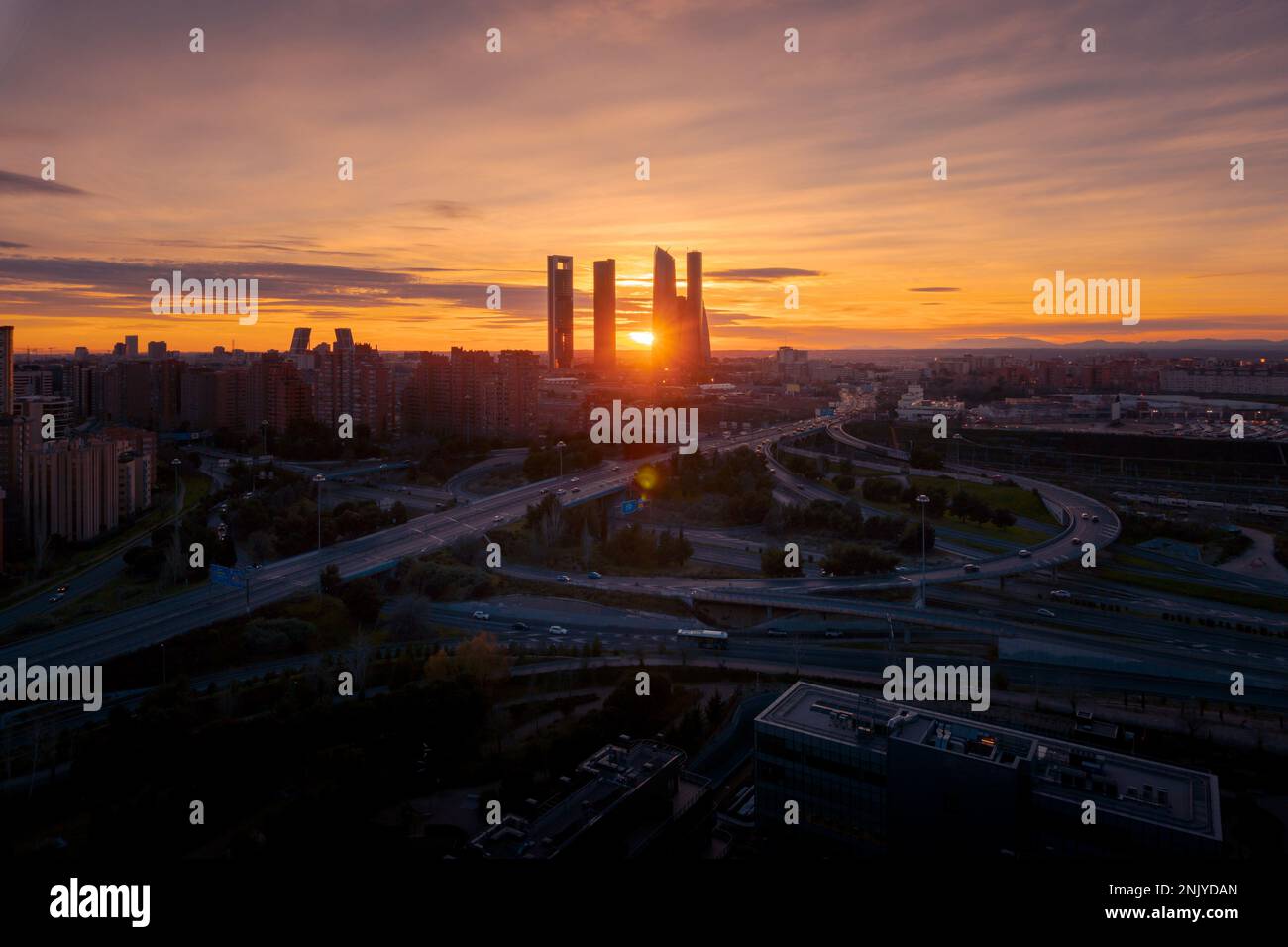 Aerial view of cityscape with skyscrapers and road against Four Towers ...
