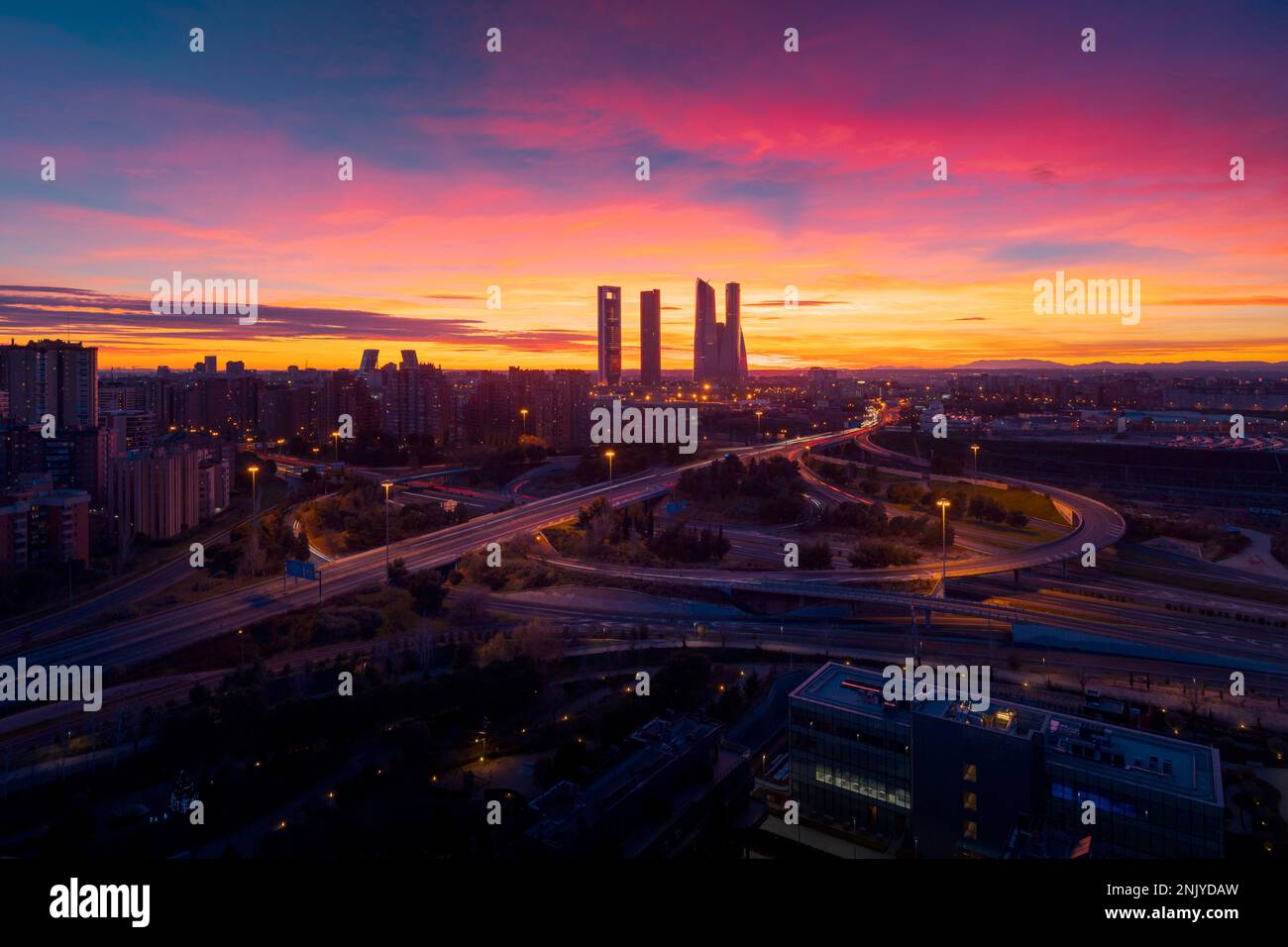 Aerial view of cityscape with skyscrapers and road against Four Towers ...