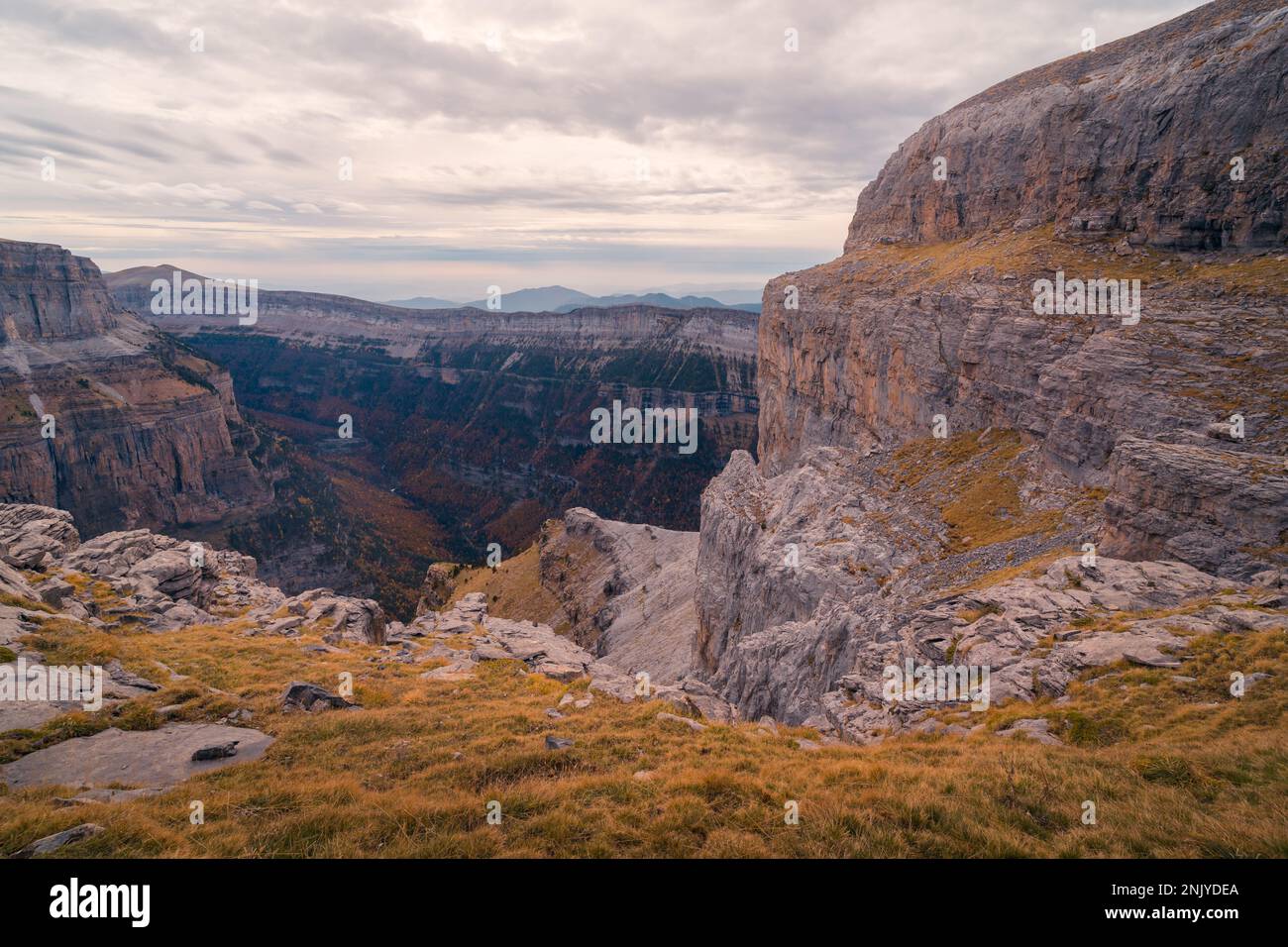 Picturesque view of rocky mountains with uneven slopes under cloudy sky ...