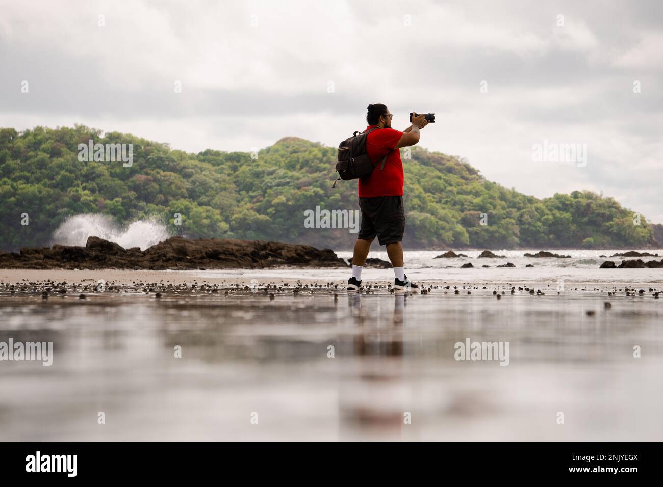 Ground level side view of bearded male traveler in casual clothes and ...