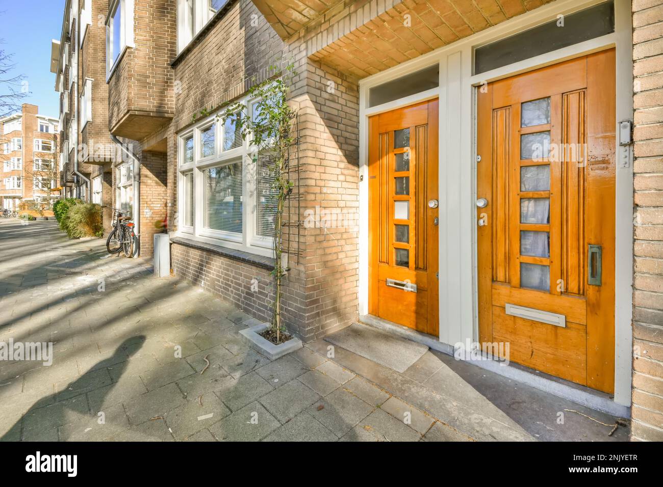 Exterior of residential building with windows and wooden doors located ...