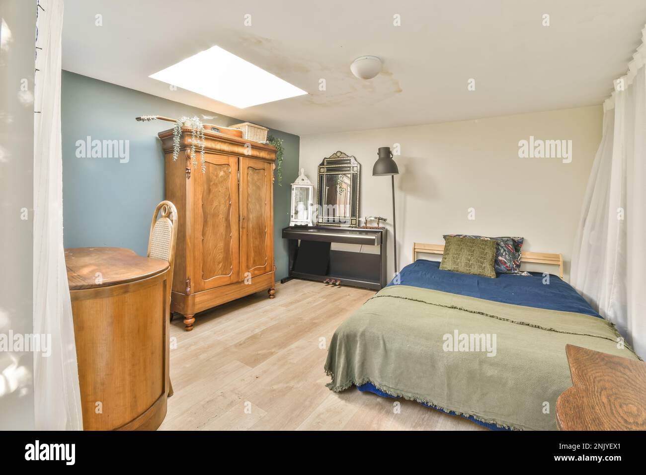 Interior of light bedroom with comfortable bed placed against wooden ...
