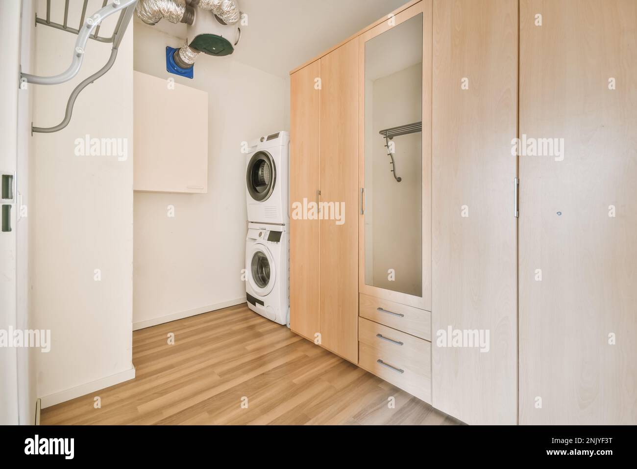 Interior of modern light laundry room with washing machines and ...