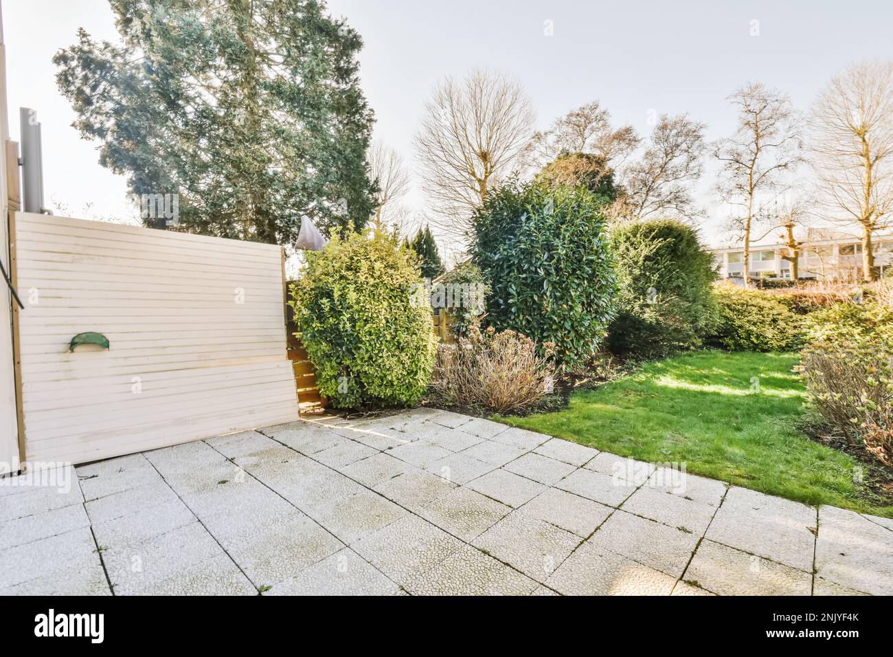 Exterior design of empty backyard of house with high fence and concrete ...