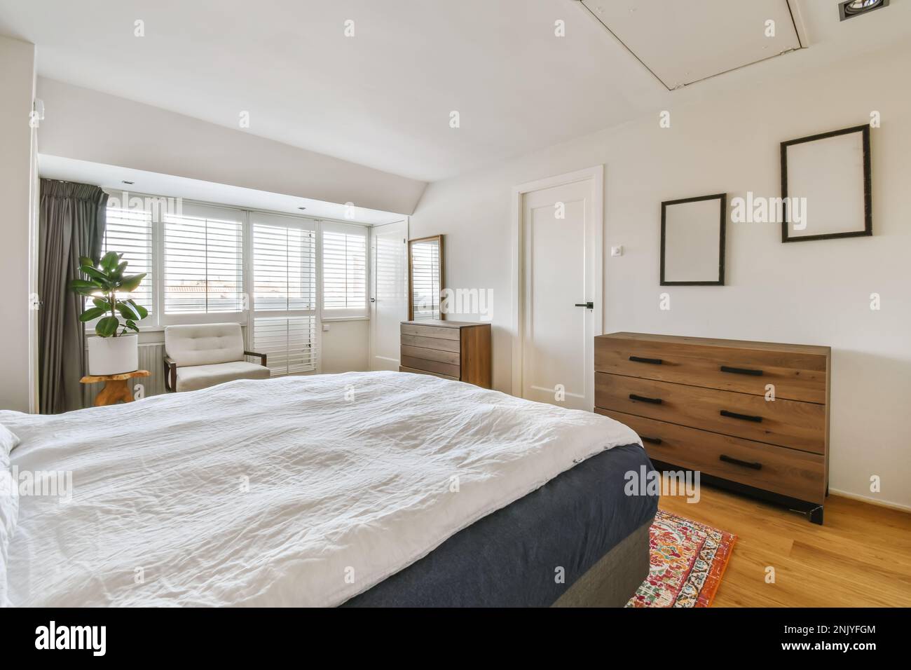 Interior design of modern bedroom with big bed placed on rug near ...