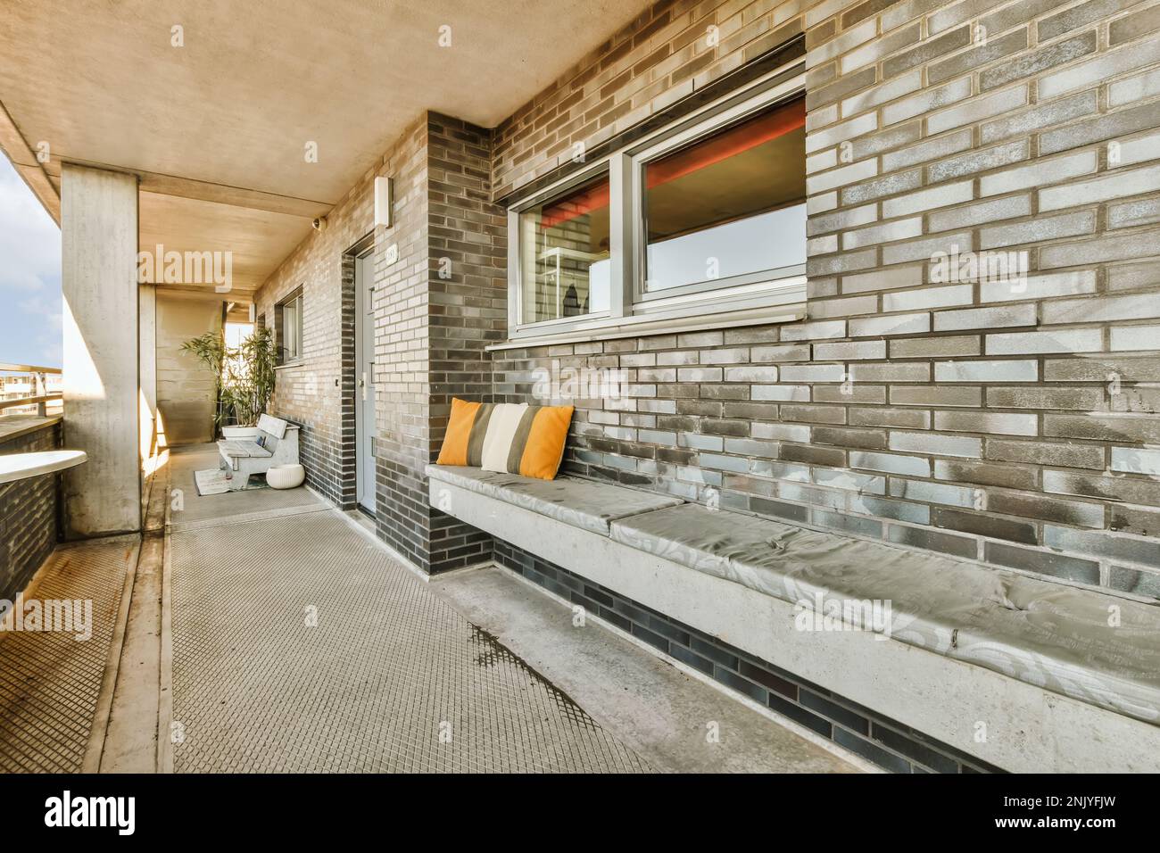 Modern spacious terrace with garden furniture and potted plant located ...