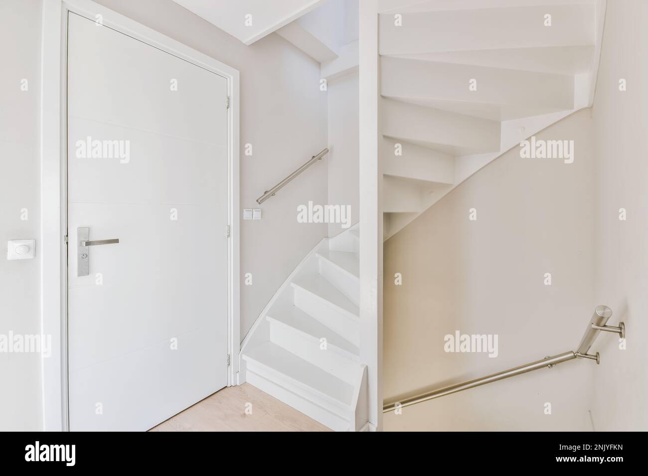 Interior design of hallway with white walls and stairs with metal ...