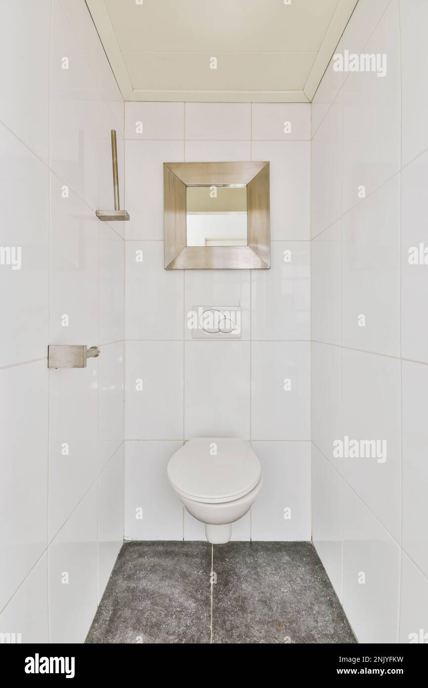 Interior design of small restroom with tiled white walls and mirror ...