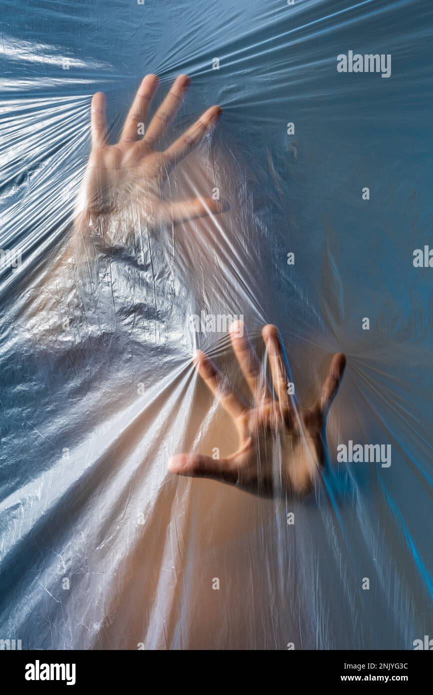 Female touching transparent cellophane while standing behind it concept ...