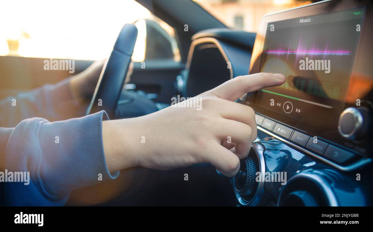 Teenager using touch screen while driving a car. Security, technology ...